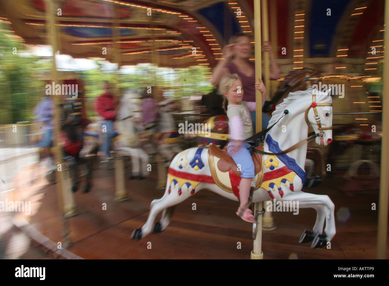 young girl enjoying carousel ride Stock Photo - Alamy