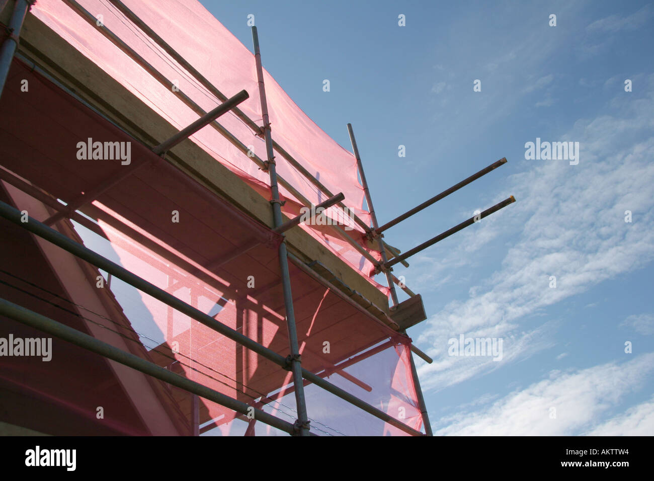 scaffolding and netting surrounding new house building Stock Photo - Alamy