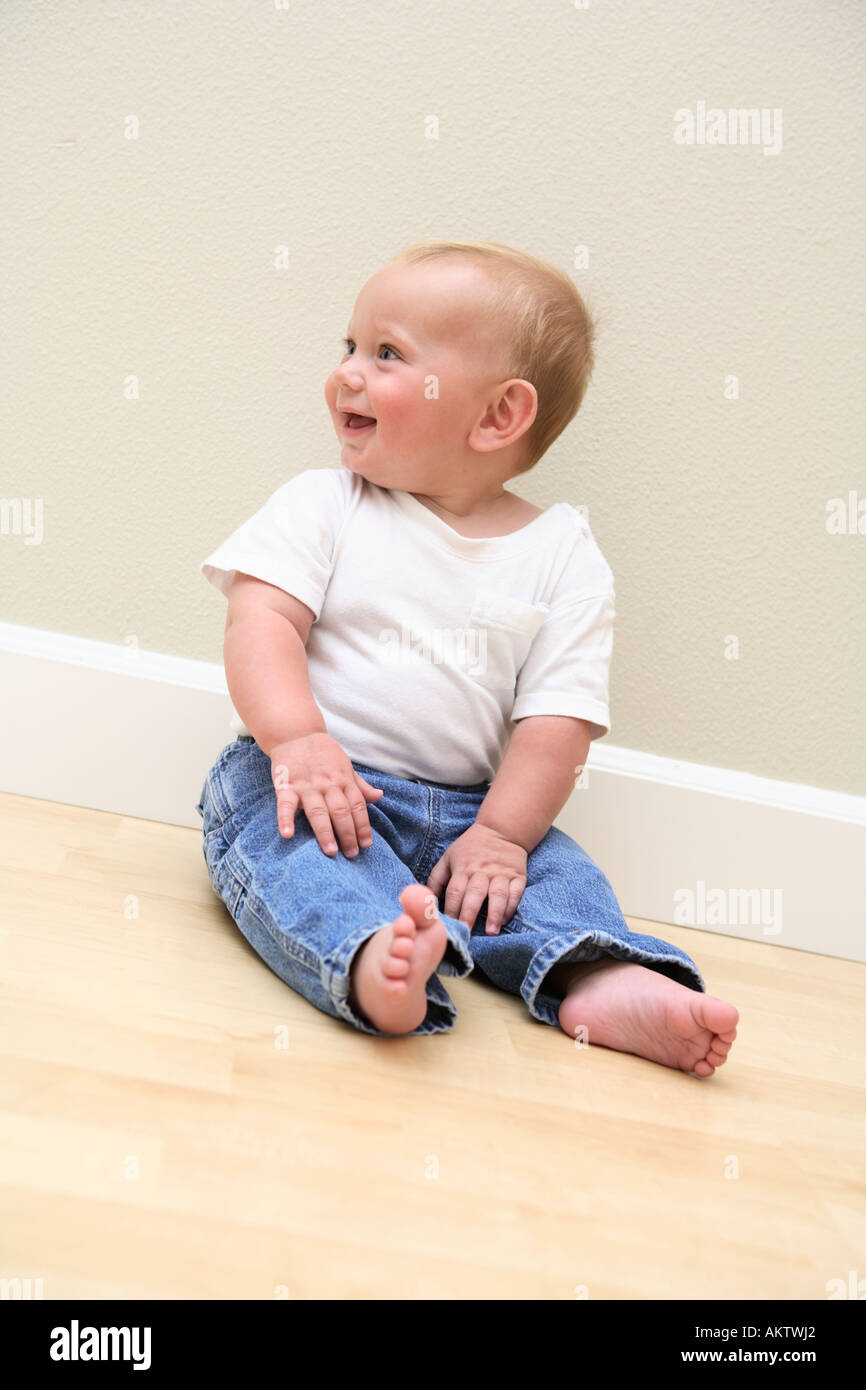 Baby Sitting on Floor Laughing Stock Photo - Alamy