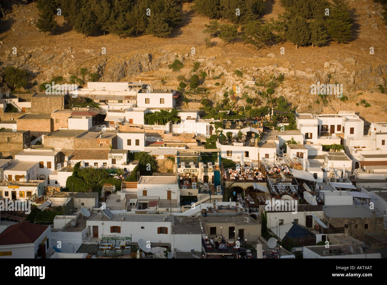 View over town in the evening people sitting on terraces of restaurants ...