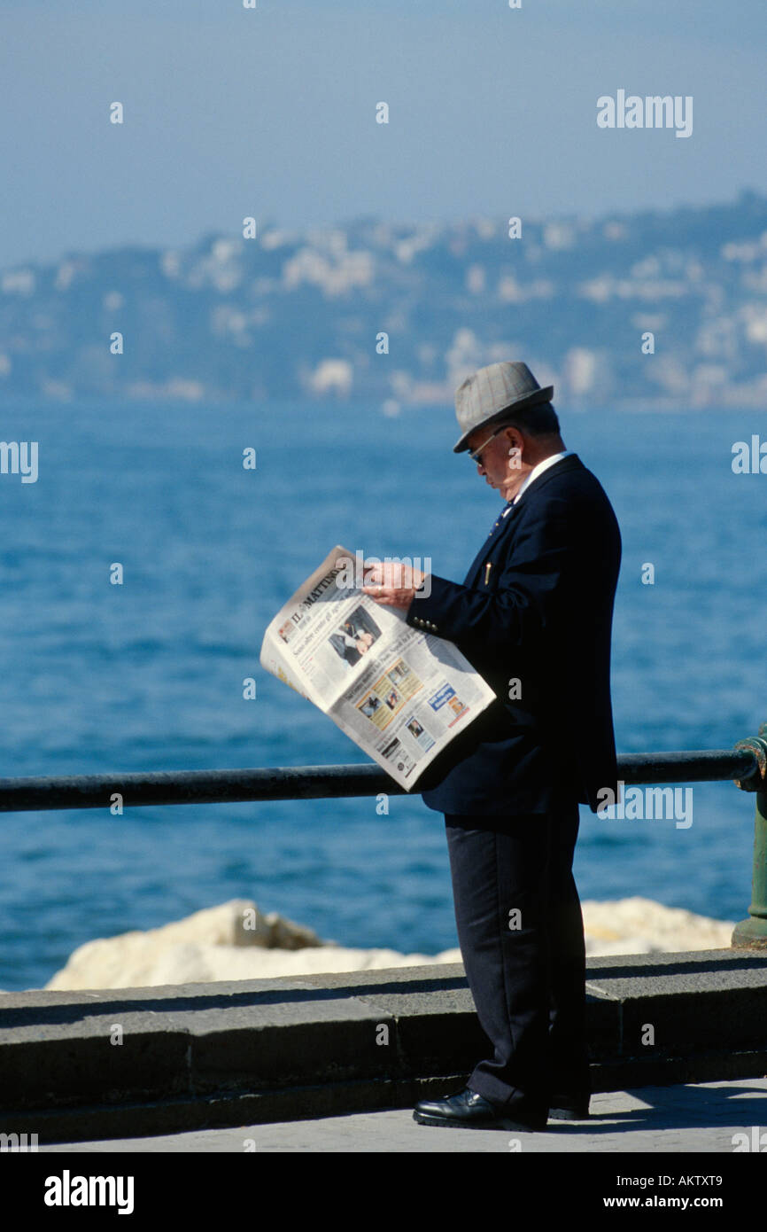 Naples Italy Man reading a newspaper on the seafront Stock Photo - Alamy