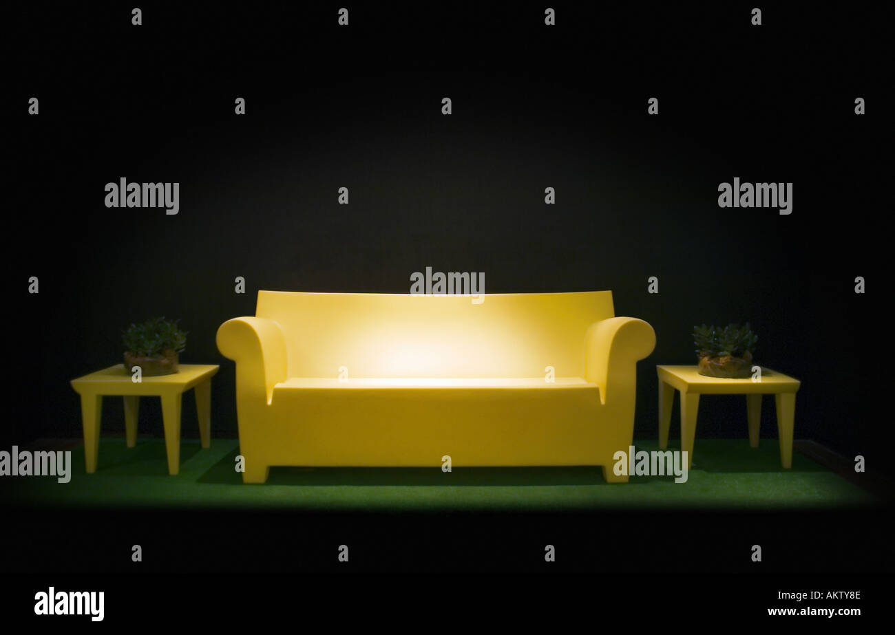 modern yellow lounge again a black wall Stock Photo - Alamy
