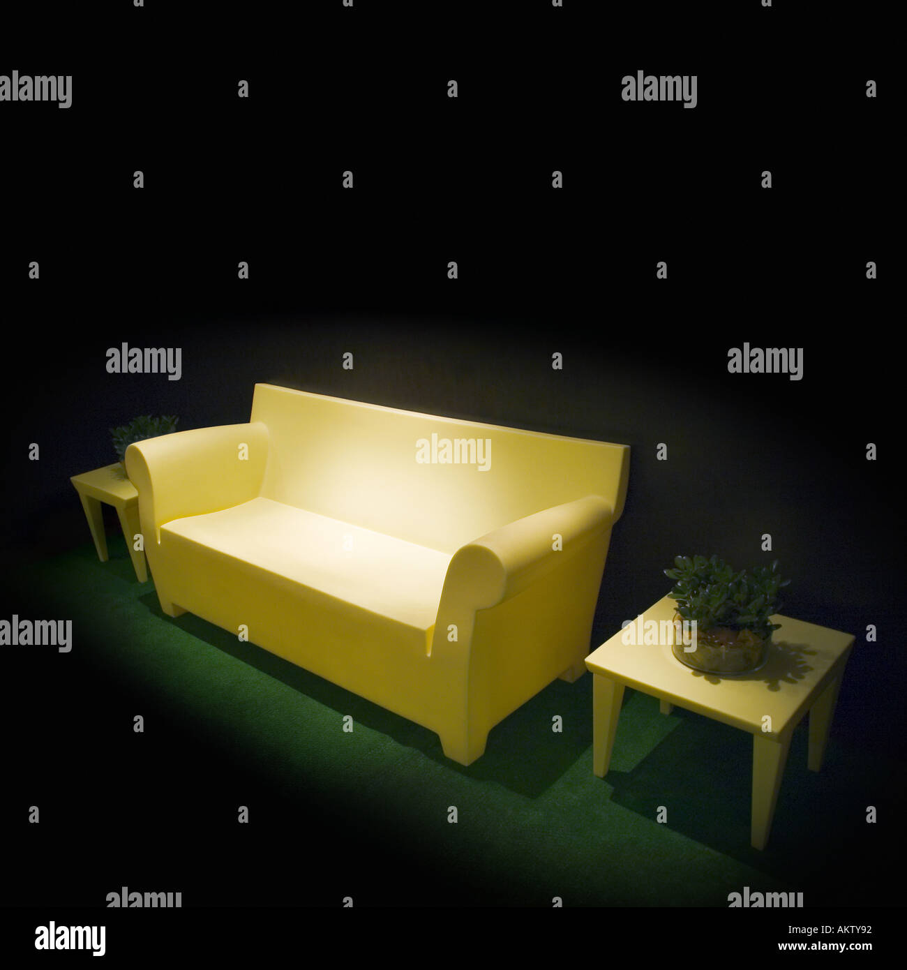 modern yellow lounge again a black wall Stock Photo - Alamy