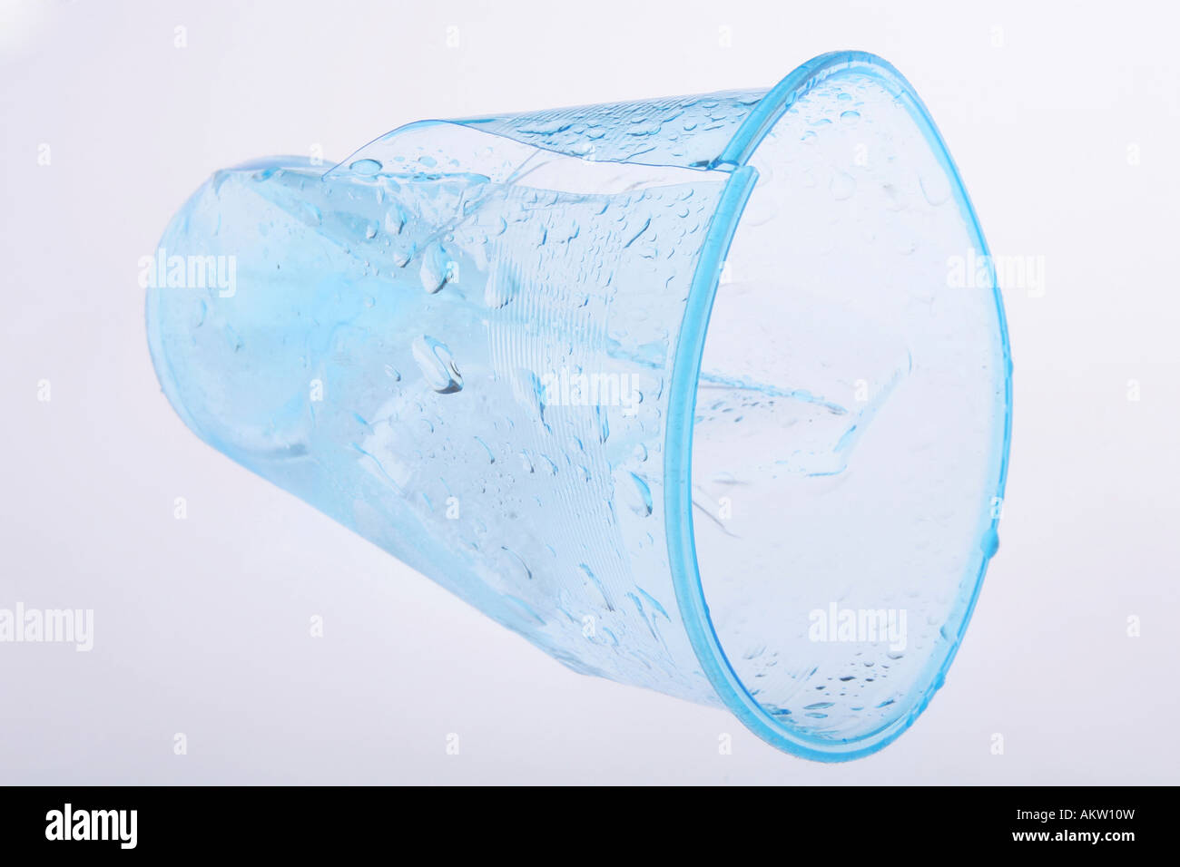Clear blue plastic cup crumbled and broken Stock Photo - Alamy