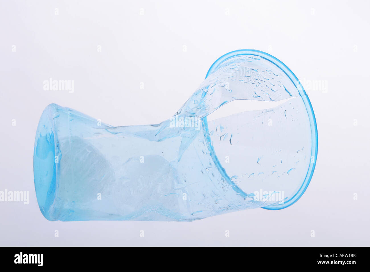 Clear blue plastic cup crumbled and broken Stock Photo - Alamy