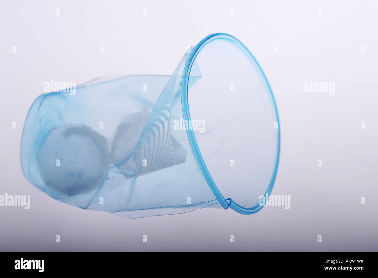 Clear blue plastic cup crumbled and broken Stock Photo - Alamy