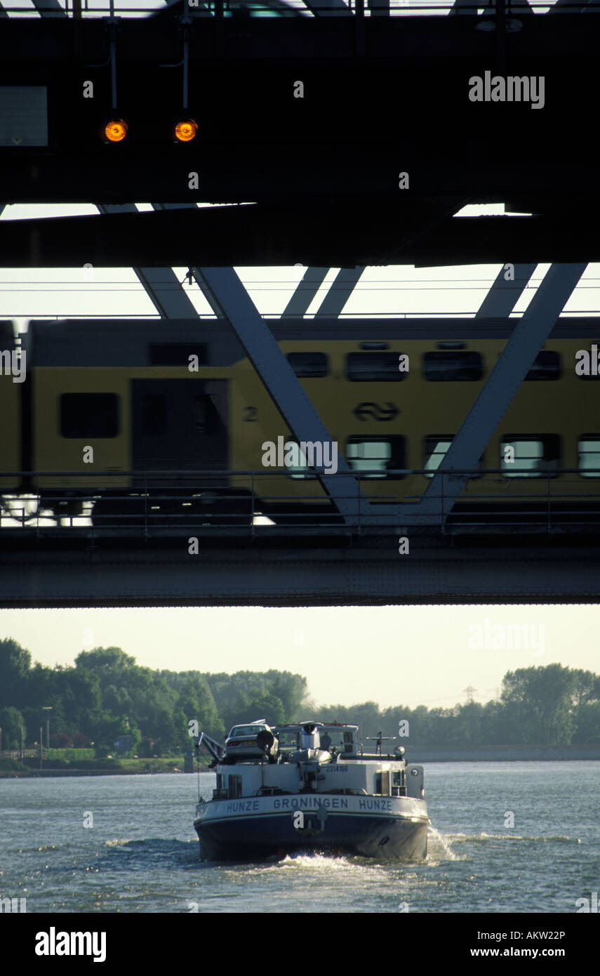 Inland shipping on the Dutch rivers a ship crossing under a railway ...