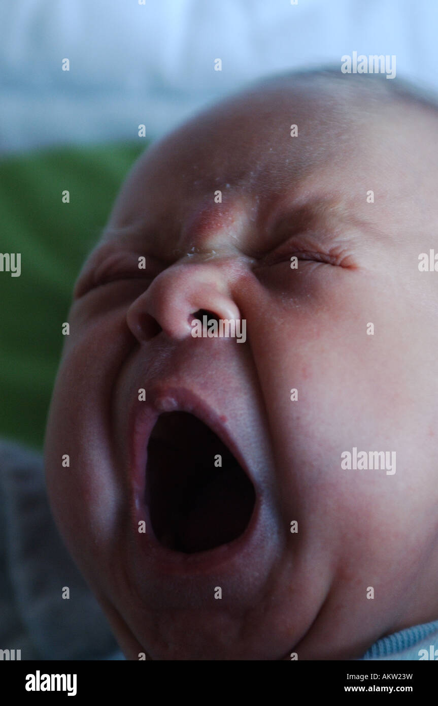 A one month old baby boy yawning Stock Photo - Alamy