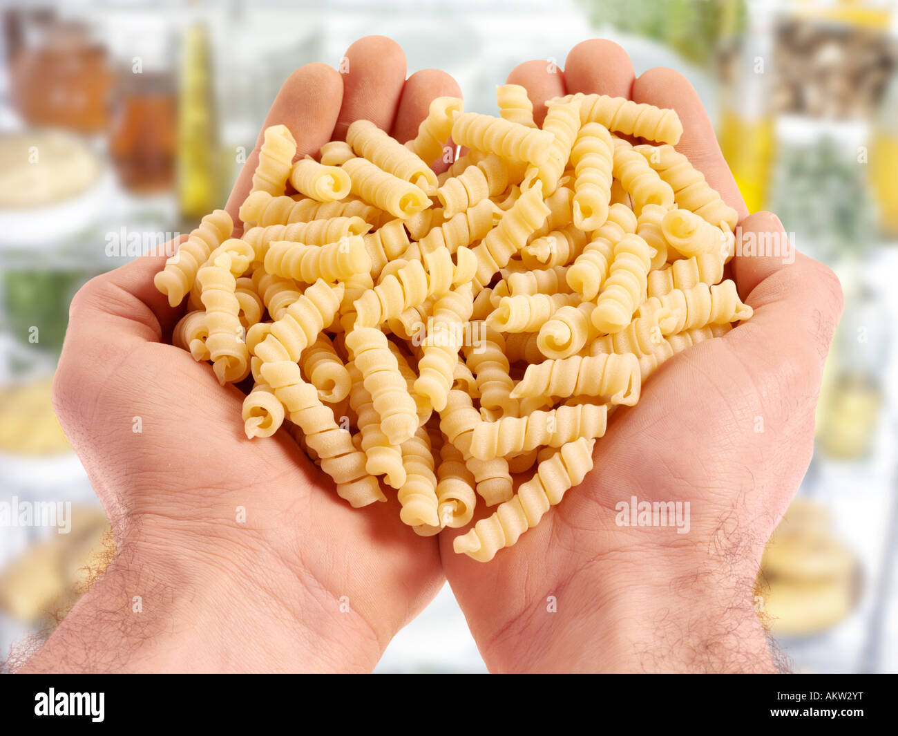 HANDFUL OF BOCCOLETTI PASTA Stock Photo - Alamy