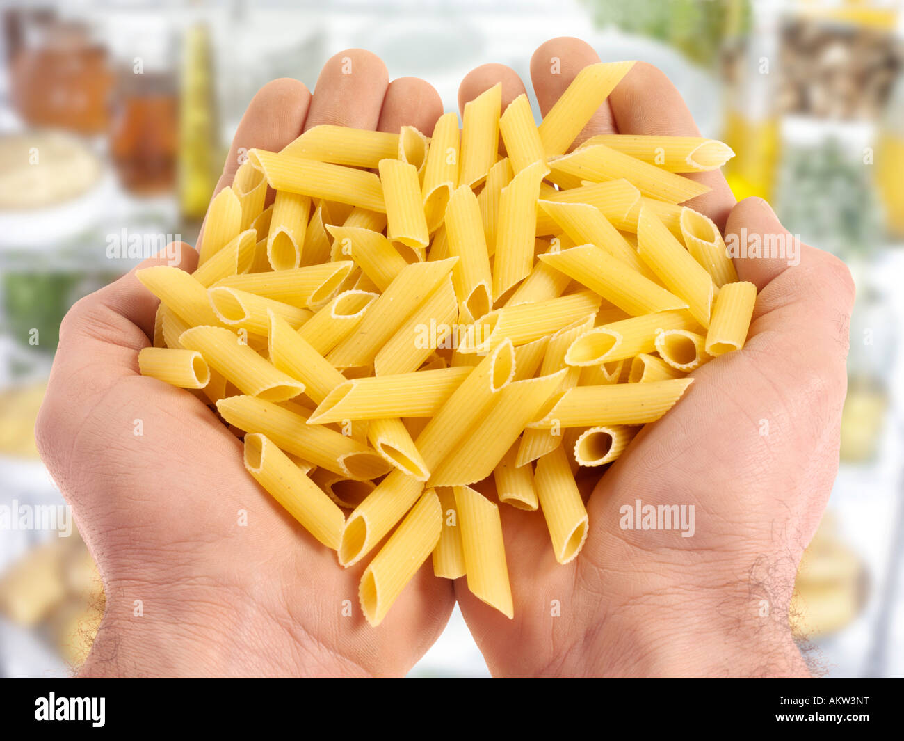 HANDFUL OF PENNE PASTA Stock Photo - Alamy