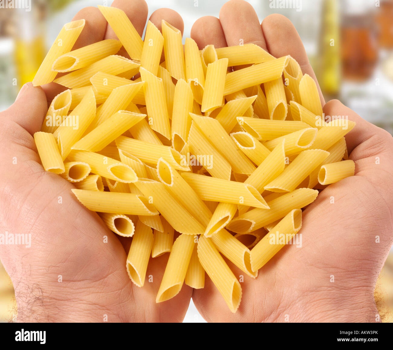 HANDFUL OF PENNE PASTA Stock Photo - Alamy