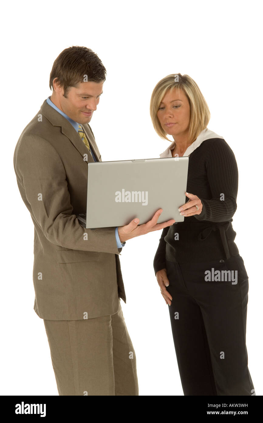 Young woman and man studying a laptop computer in an office environment ...