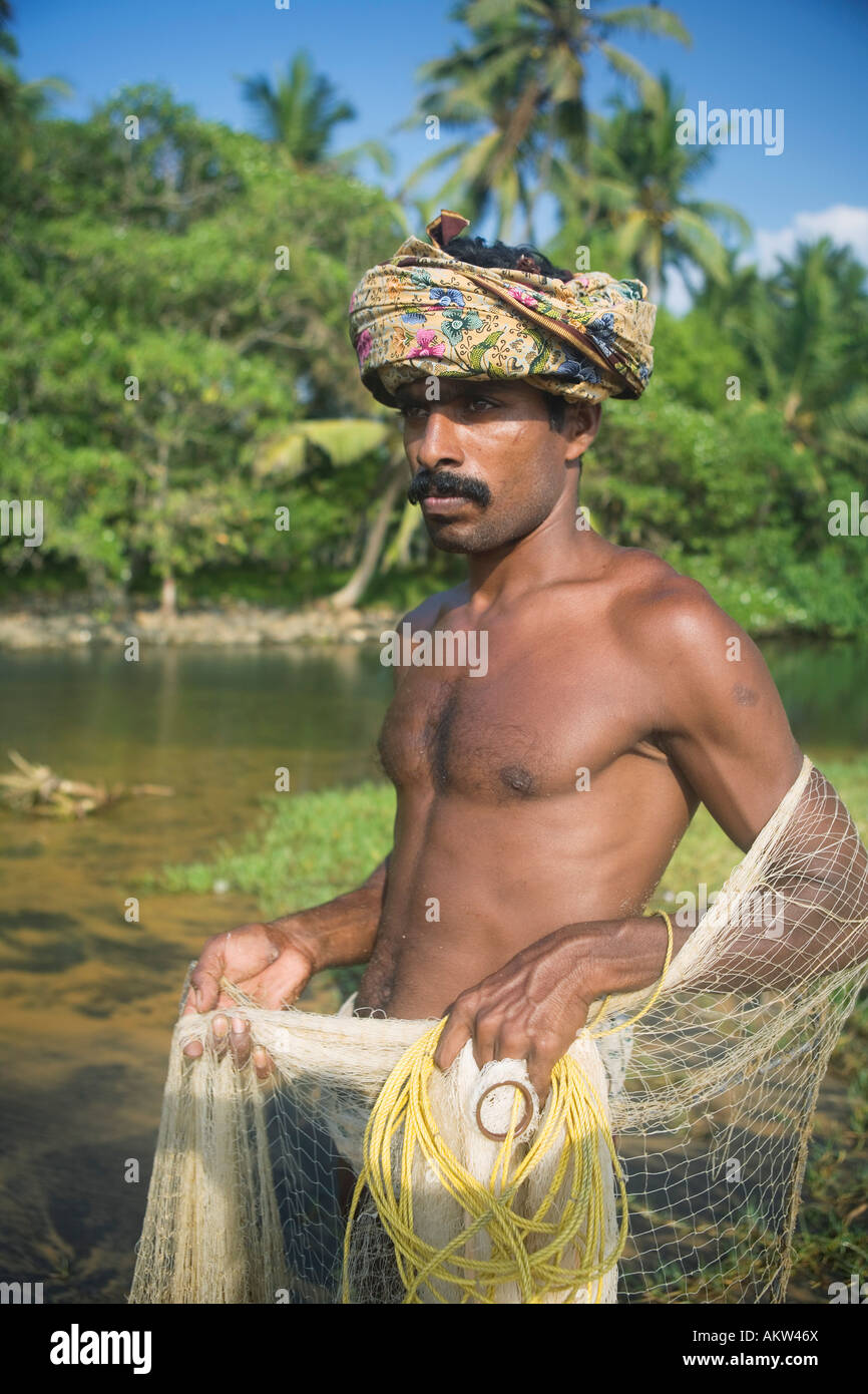 BACKWATERS FISHERMAN WITH NET Stock Photo - Alamy