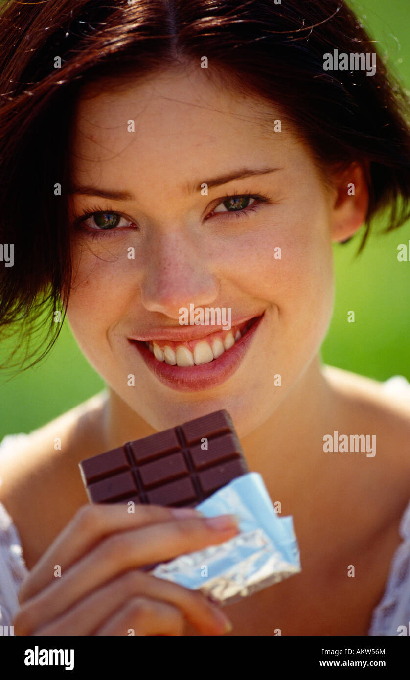 Girl eating chocolate Stock Photo - Alamy