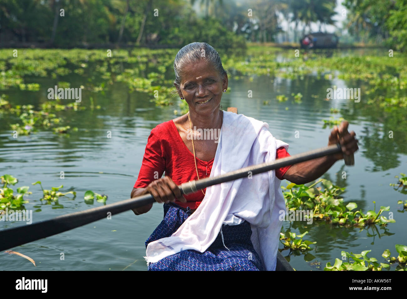 INDIA KERALA BACKWATERS WOMAN ROWING BOAT ON WATERWAYS Stock Photo - Alamy