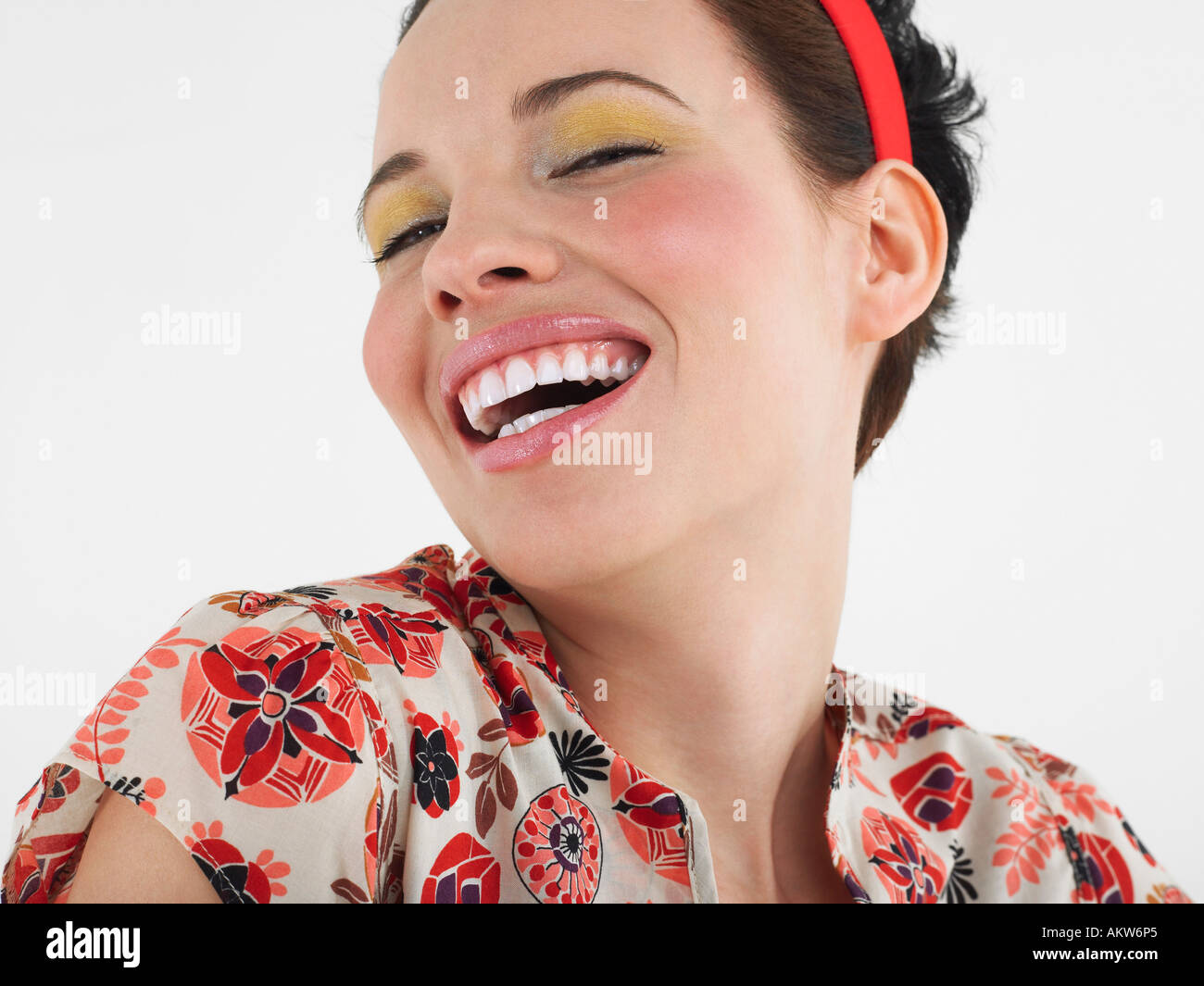 Woman laughing, head and shoulders, in studio Stock Photo - Alamy
