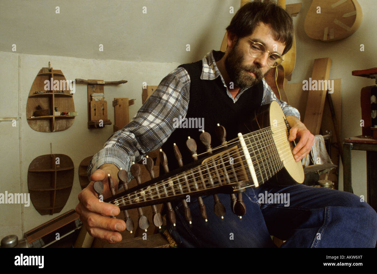 in workshop tuning / playing lute Stock Photo - Alamy