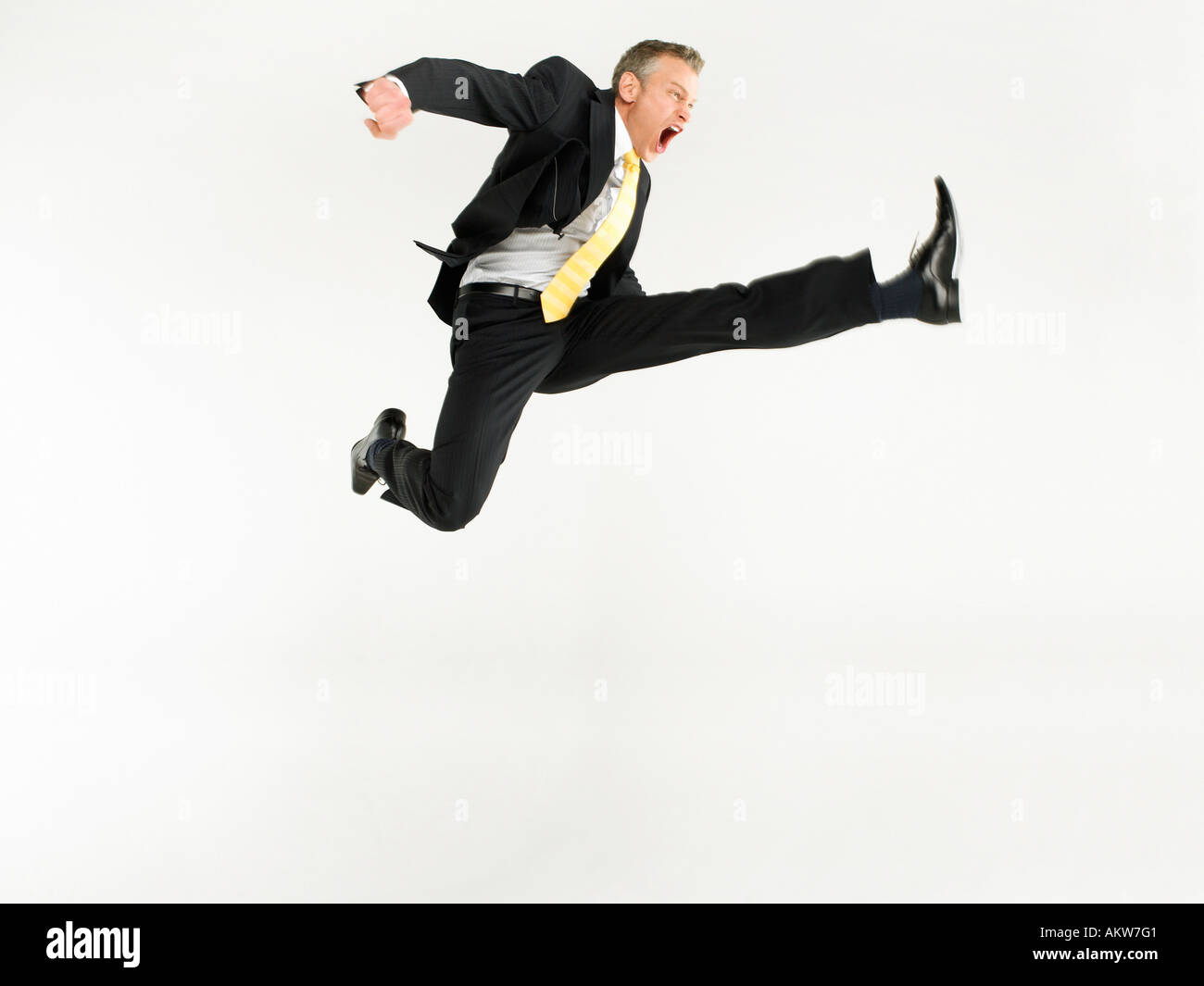 Business man jumping, full length Stock Photo - Alamy