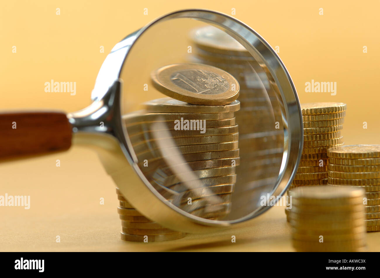 Euro coins under magnifying glass, close-up Stock Photo - Alamy