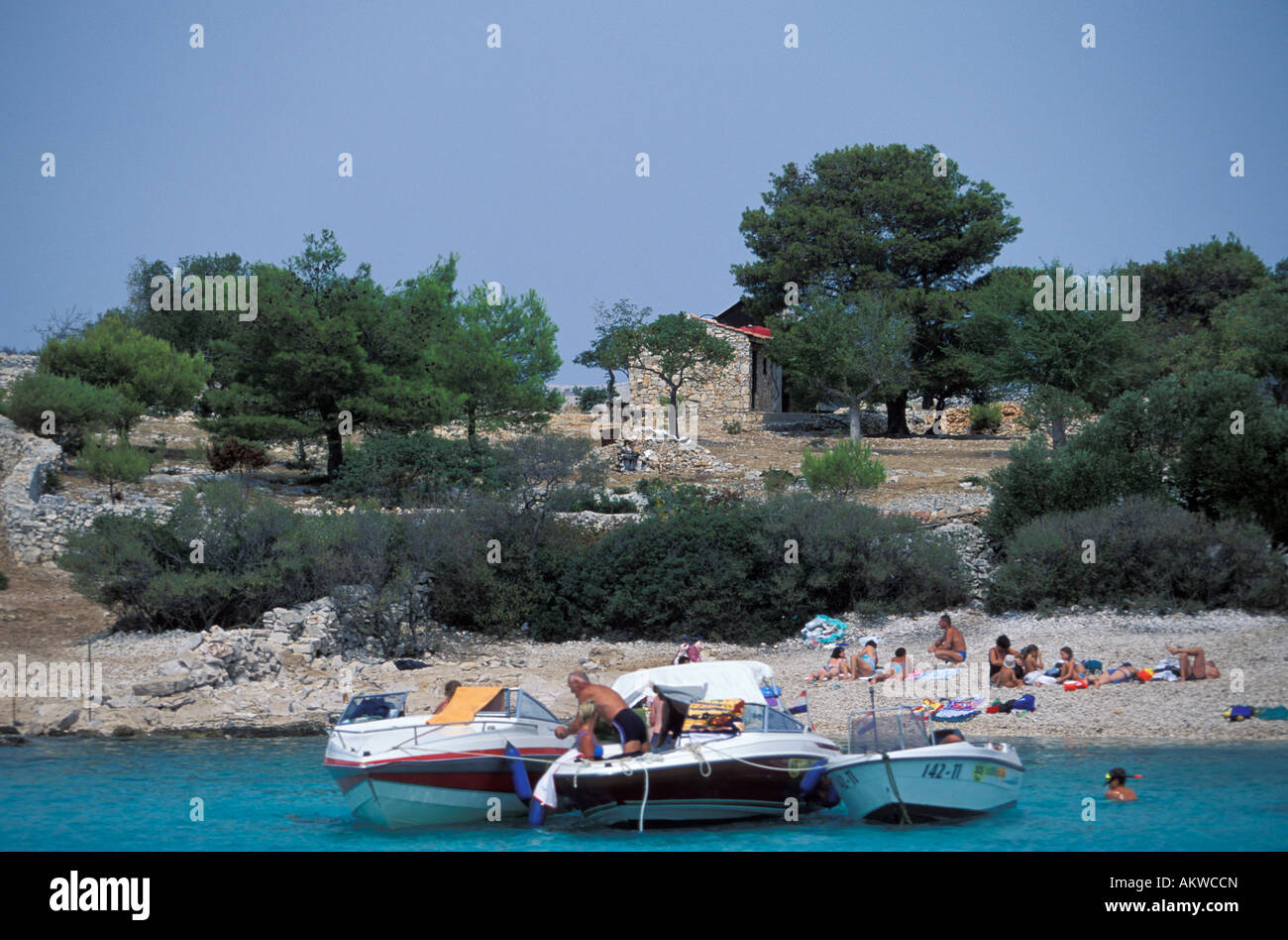 Tourists on boats near beach Levrnaka island Kornati National Park ...