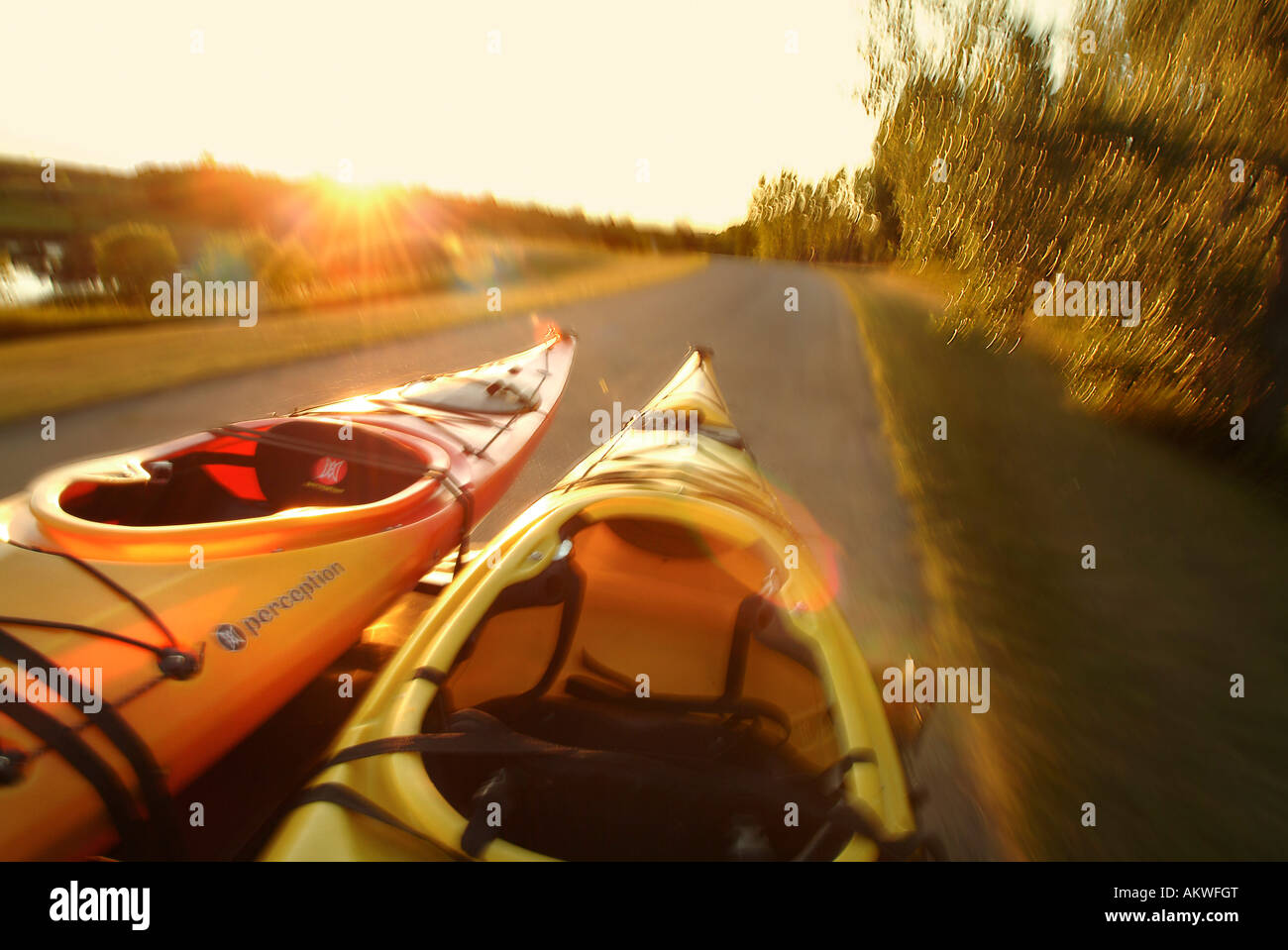 Kayaks on a roof rack as the car drives down a winding road Stock Photo ...