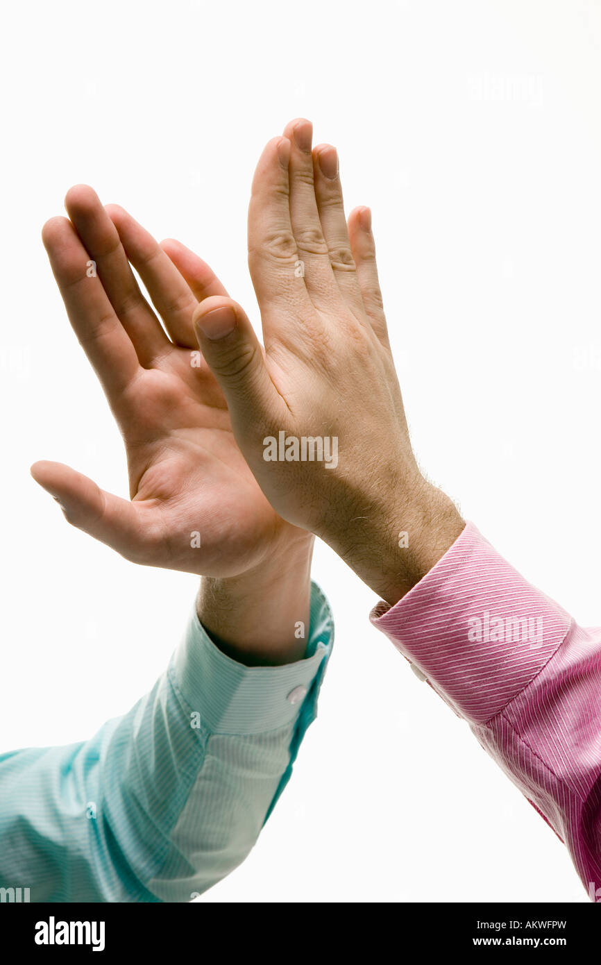 Businessmen slapping palms, close-up Stock Photo - Alamy