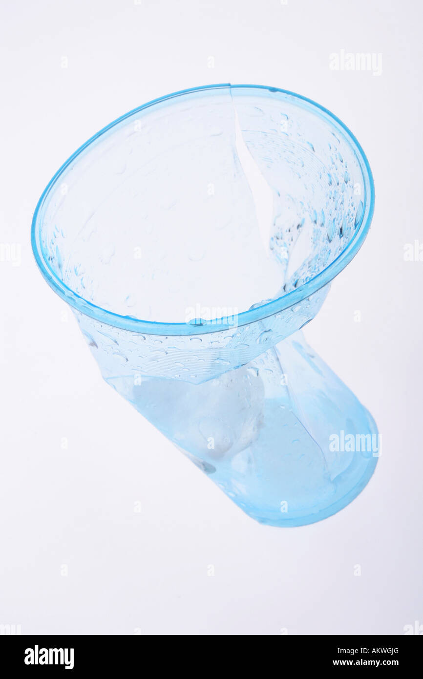 Clear blue plastic cup crumbled and broken Stock Photo - Alamy