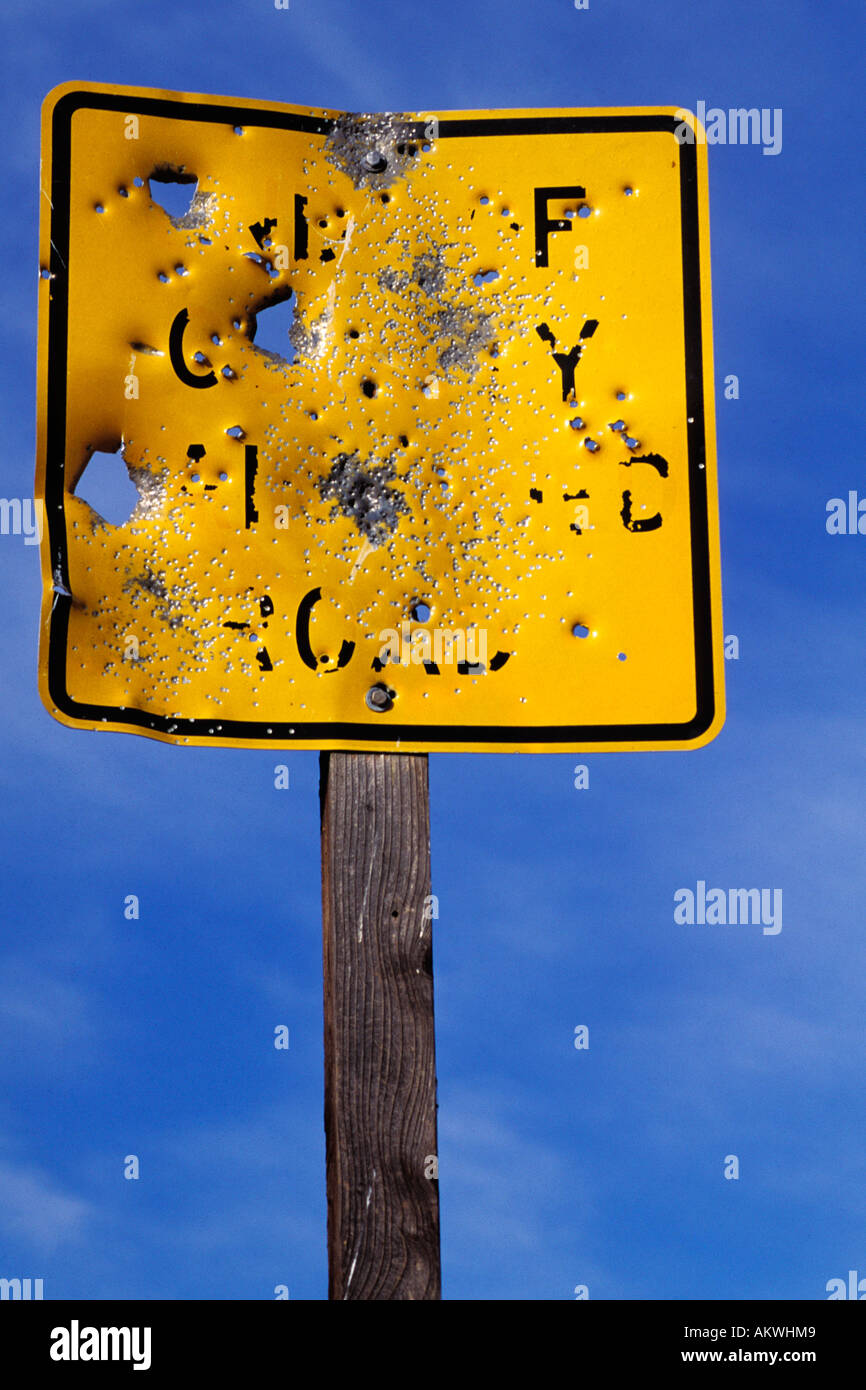 Sign, Target practice on road sign Stock Photo - Alamy