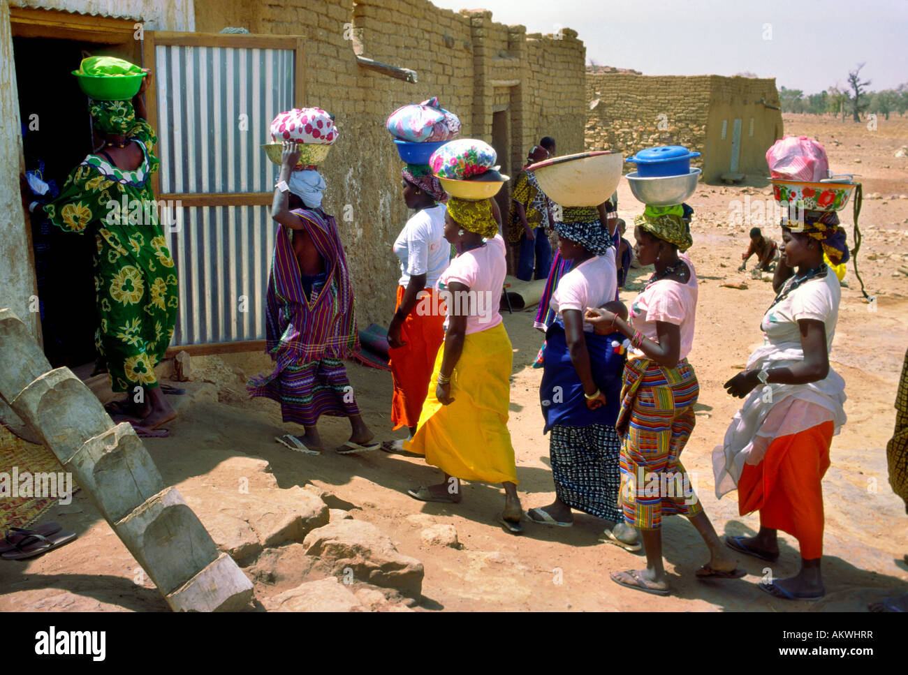 Women from a neighboring village arrive with food supplies on their ...