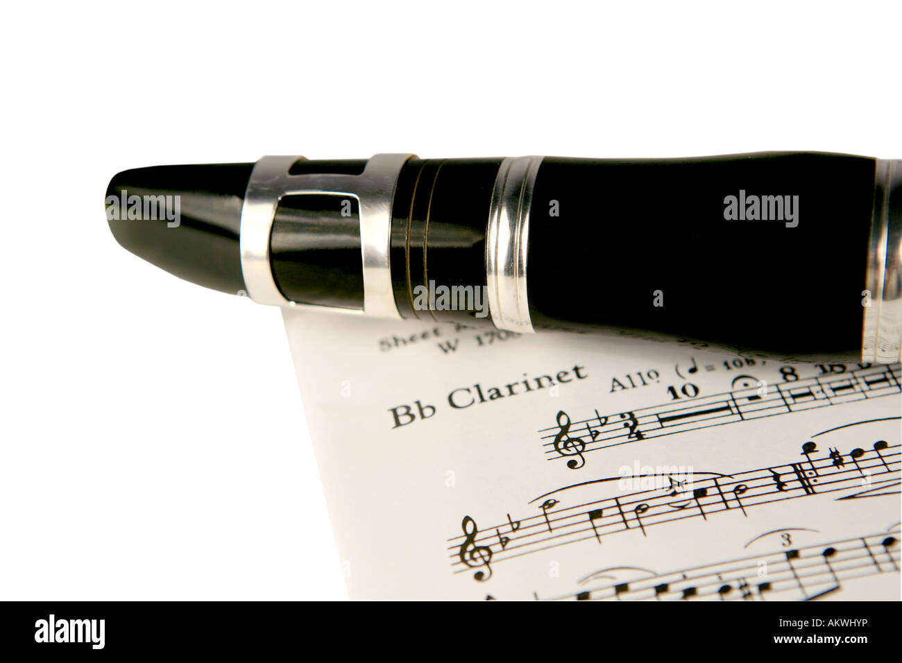 Clarinet on top of sheet music isolated on white Stock Photo - Alamy