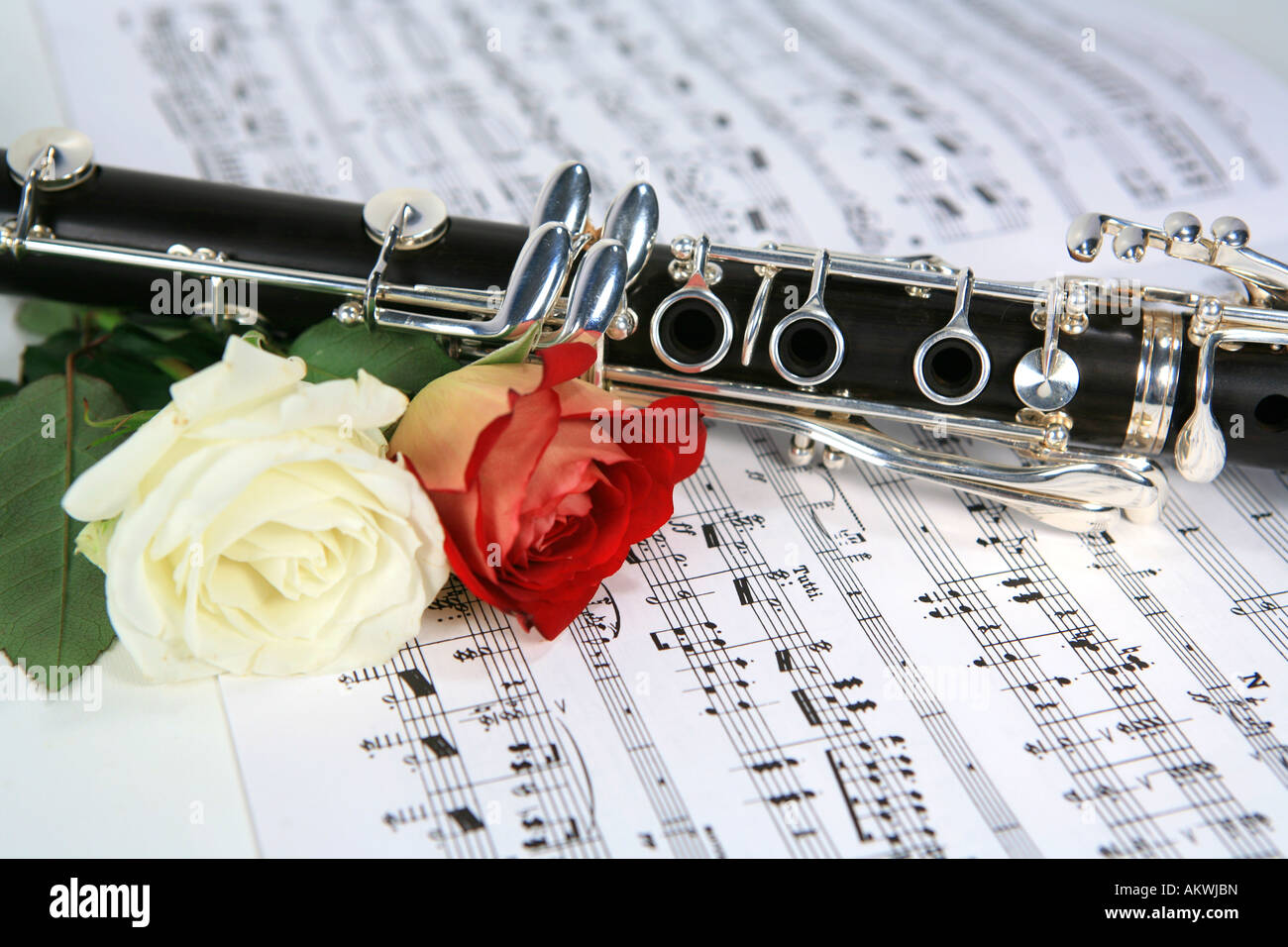 B flat clarinet with a red and a white rose on sheet music Stock Photo ...