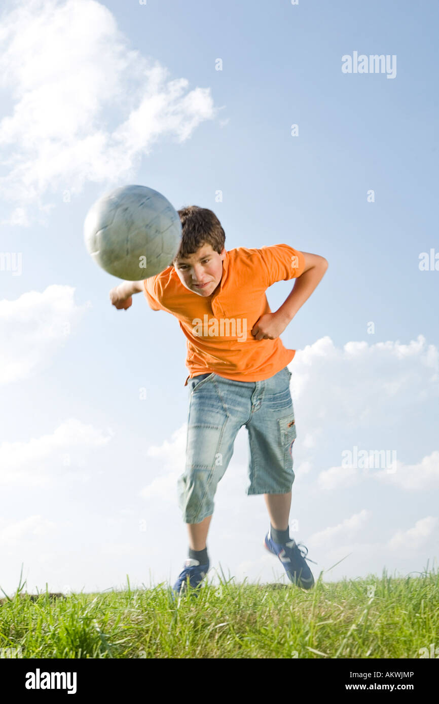 Boy playing football Stock Photo - Alamy