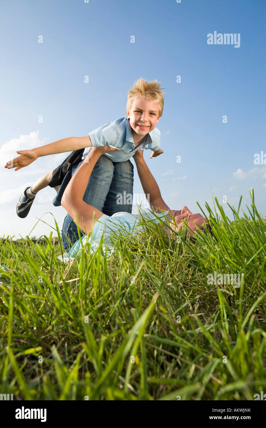 Father lifting son Stock Photo - Alamy