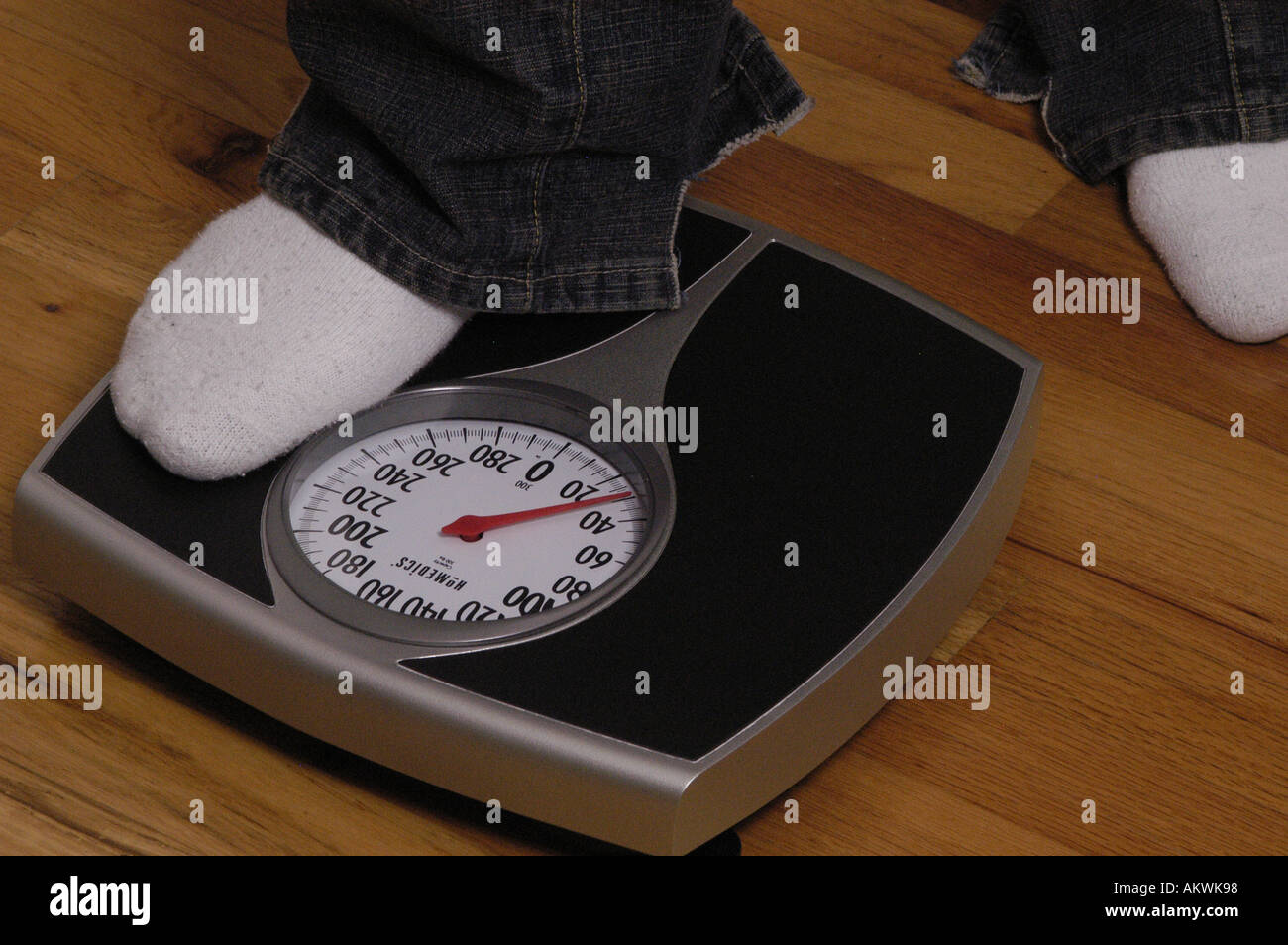 A man's feet on a scale, weighting himself Stock Photo - Alamy