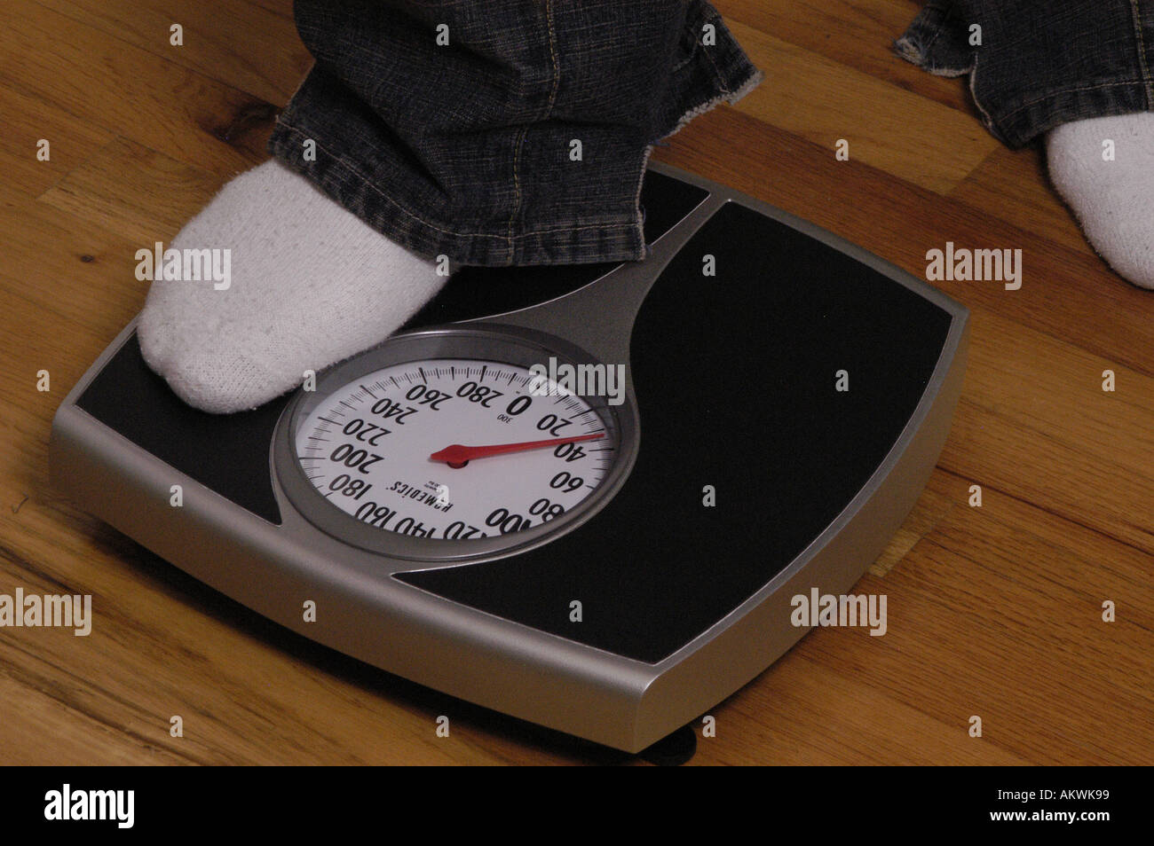 A man's feet on a scale, weighting himself Stock Photo - Alamy