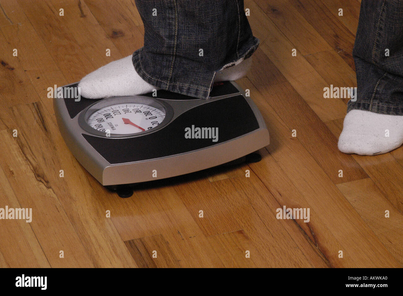A man's feet on a scale, weighting himself Stock Photo - Alamy