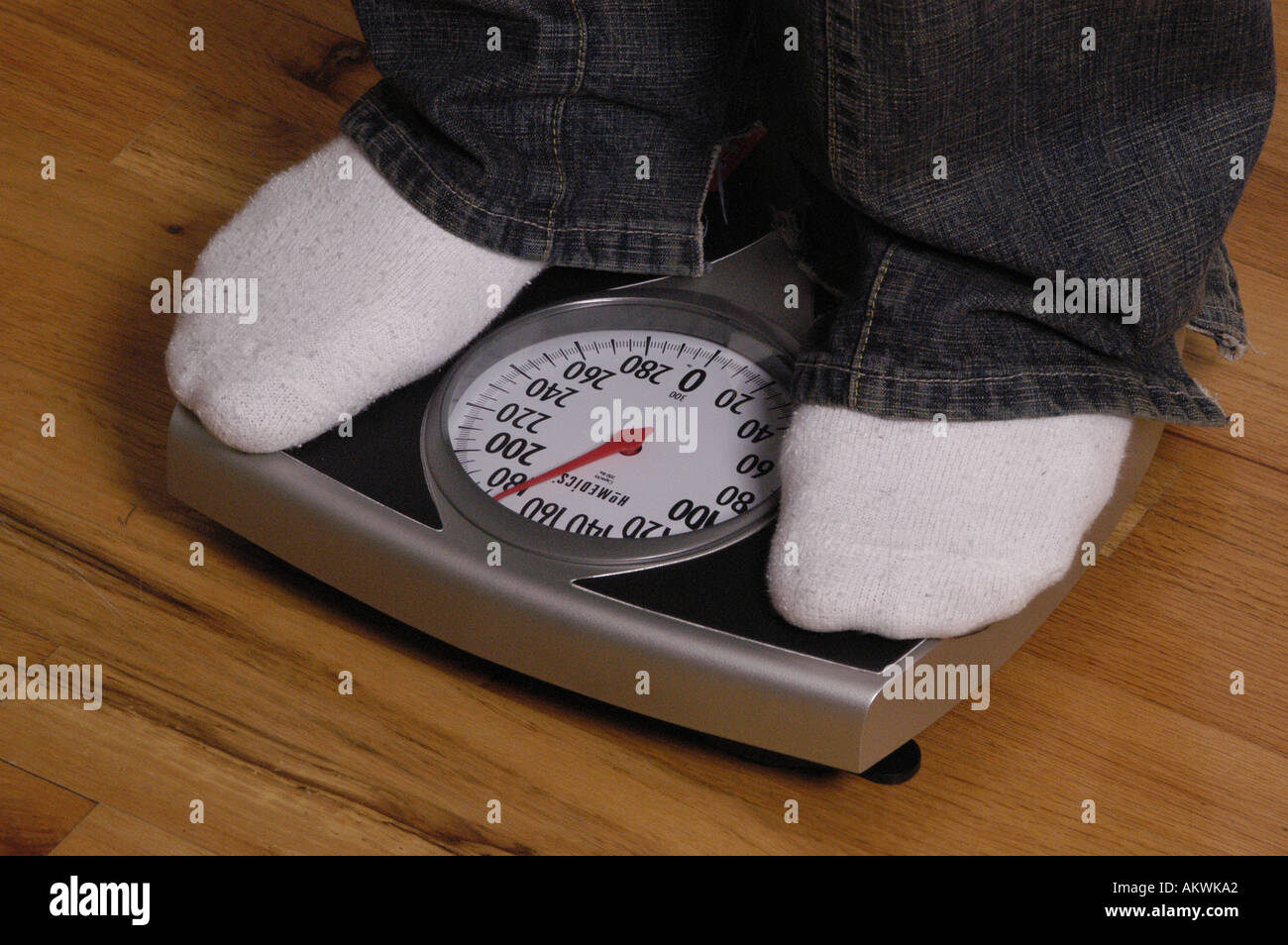 A man's feet on a scale, weighting himself Stock Photo - Alamy