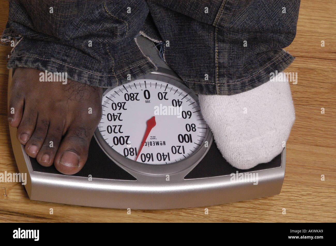 A man's feet on a scale, weighting himself Stock Photo - Alamy
