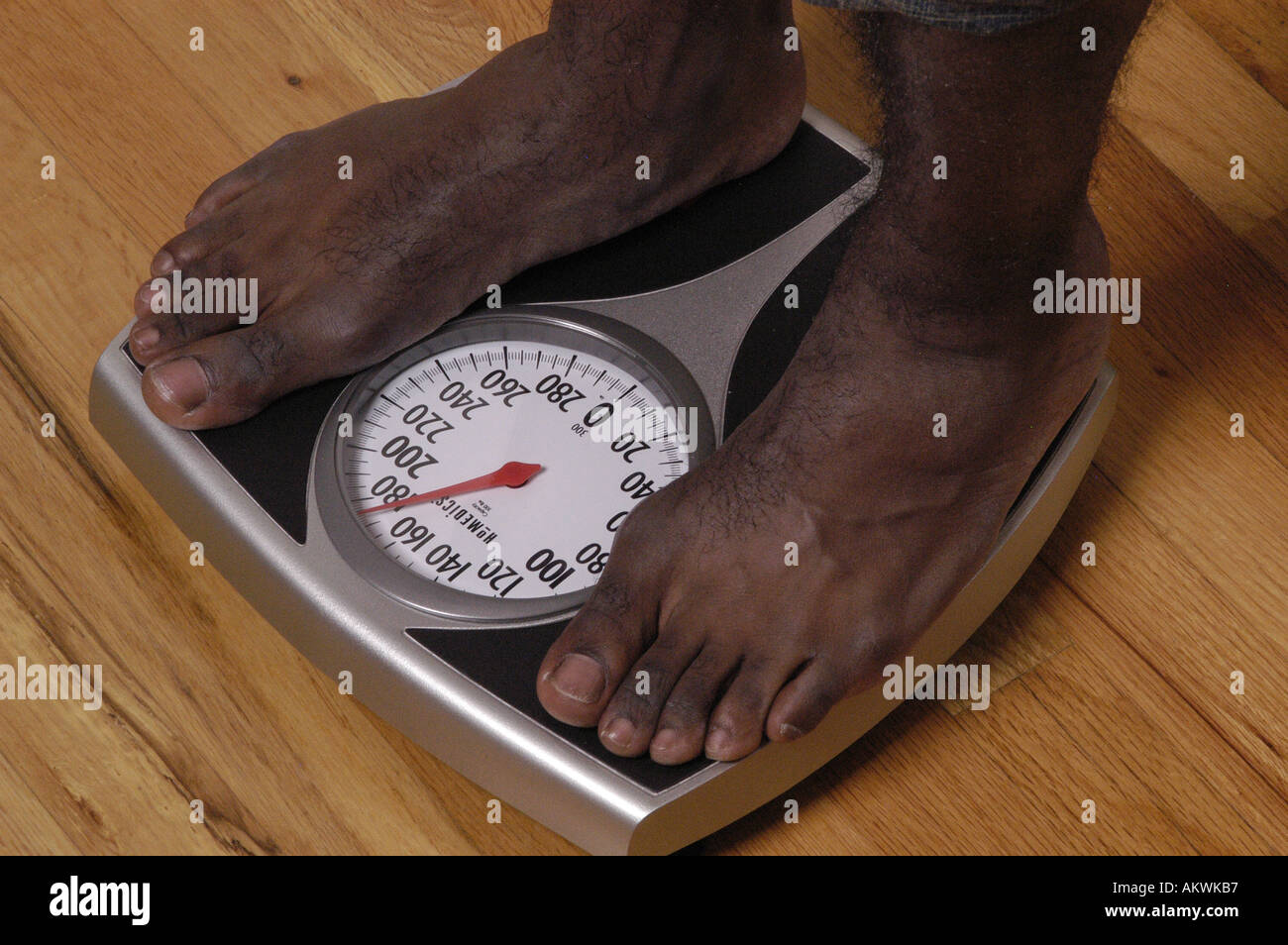 A man's feet on a scale, weighting himself Stock Photo - Alamy