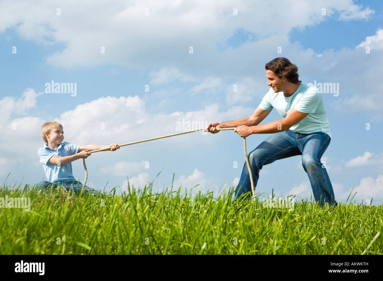 Father and son pulling rope Stock Photo - Alamy