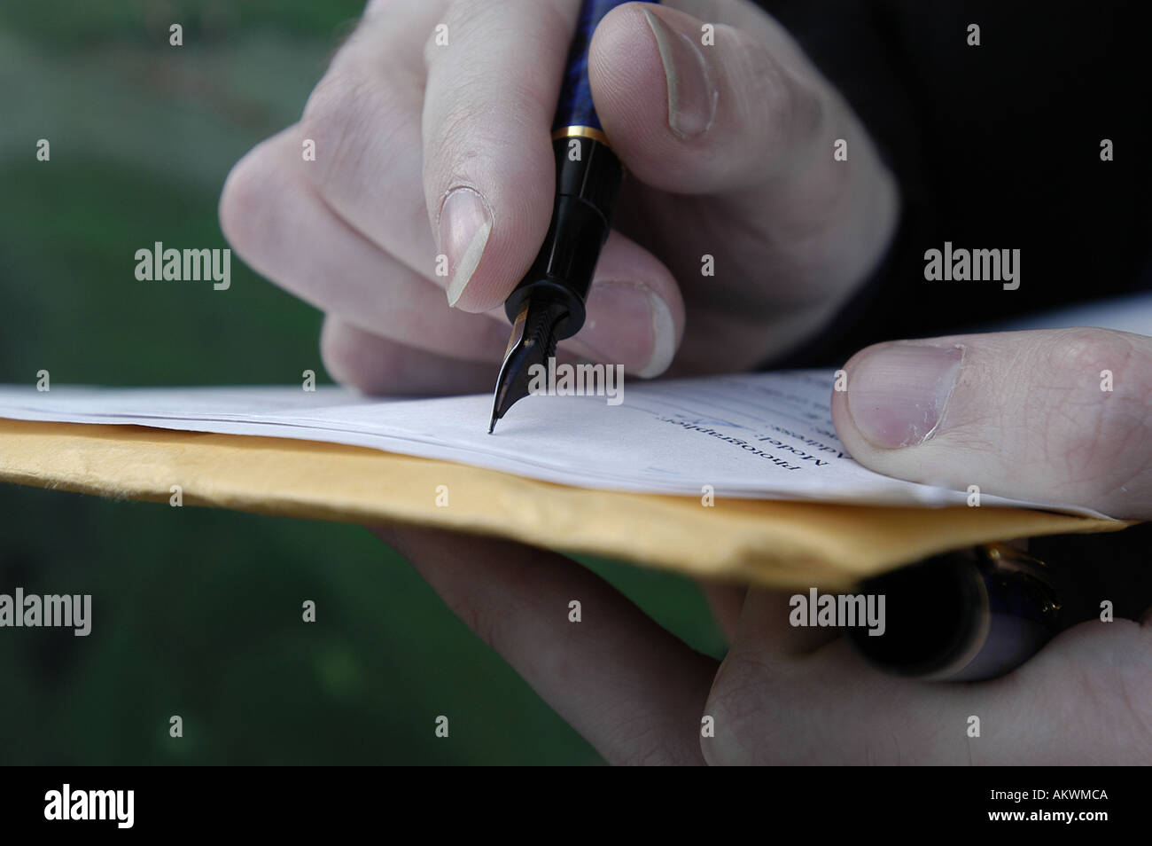 A close-up of a hand writing in a journal Stock Photo - Alamy