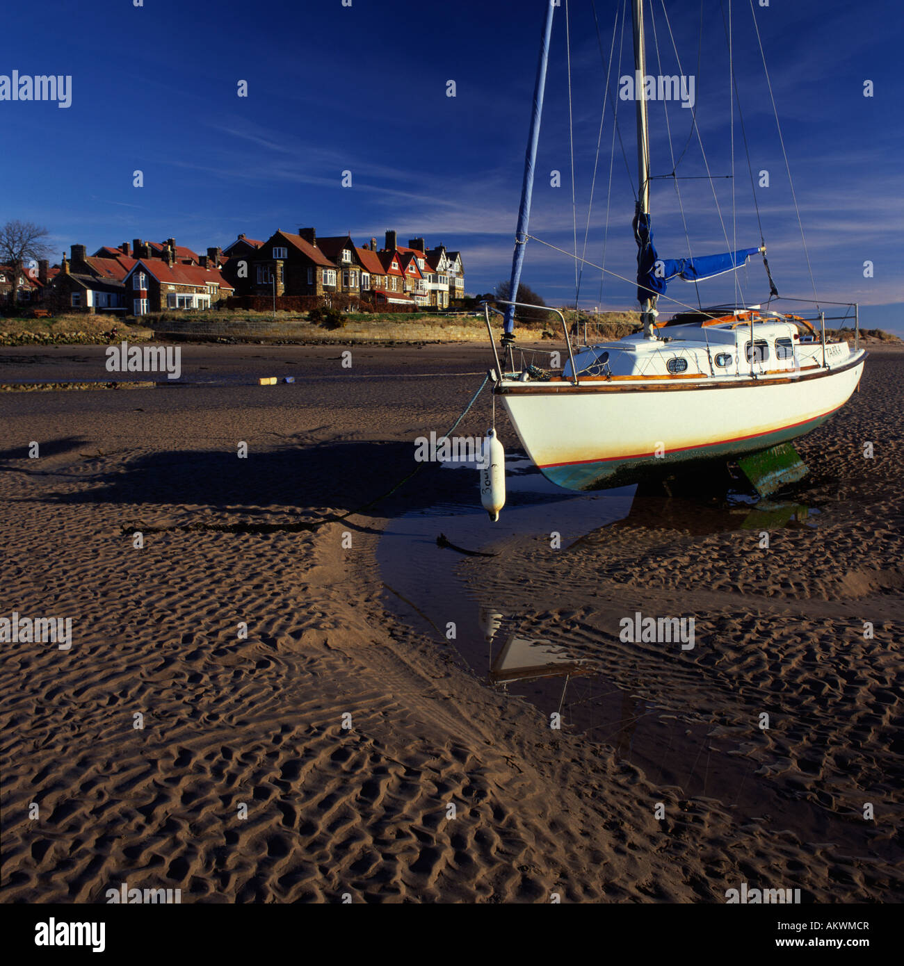 White boat on Aln Estuary at low tide at Alnmouth, Northumberland, UK ...