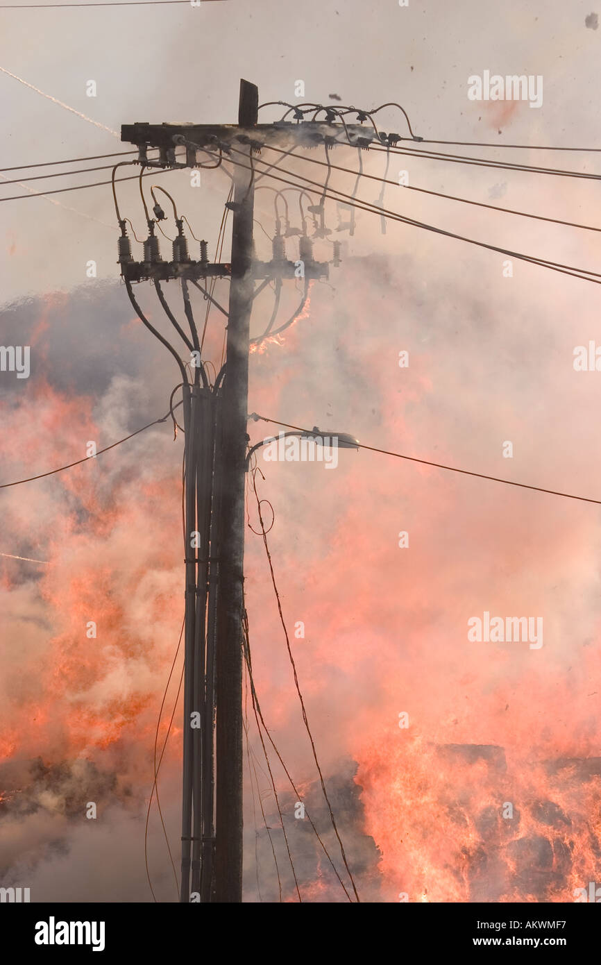 Burning power pole on fire at an industrial fire Stock Photo - Alamy