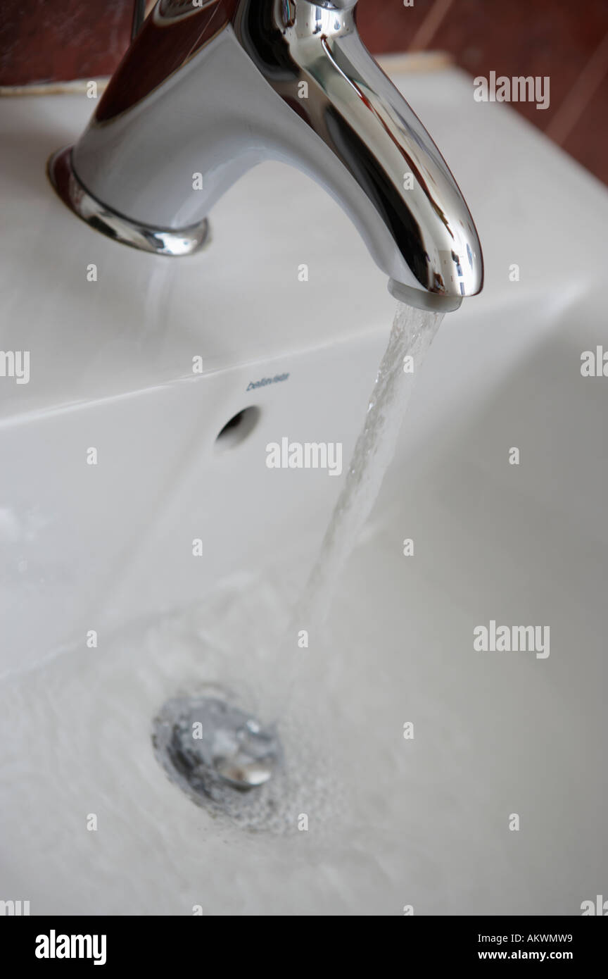 BATHROOM TAP POURING WATER INTO WASH BASIN Stock Photo - Alamy