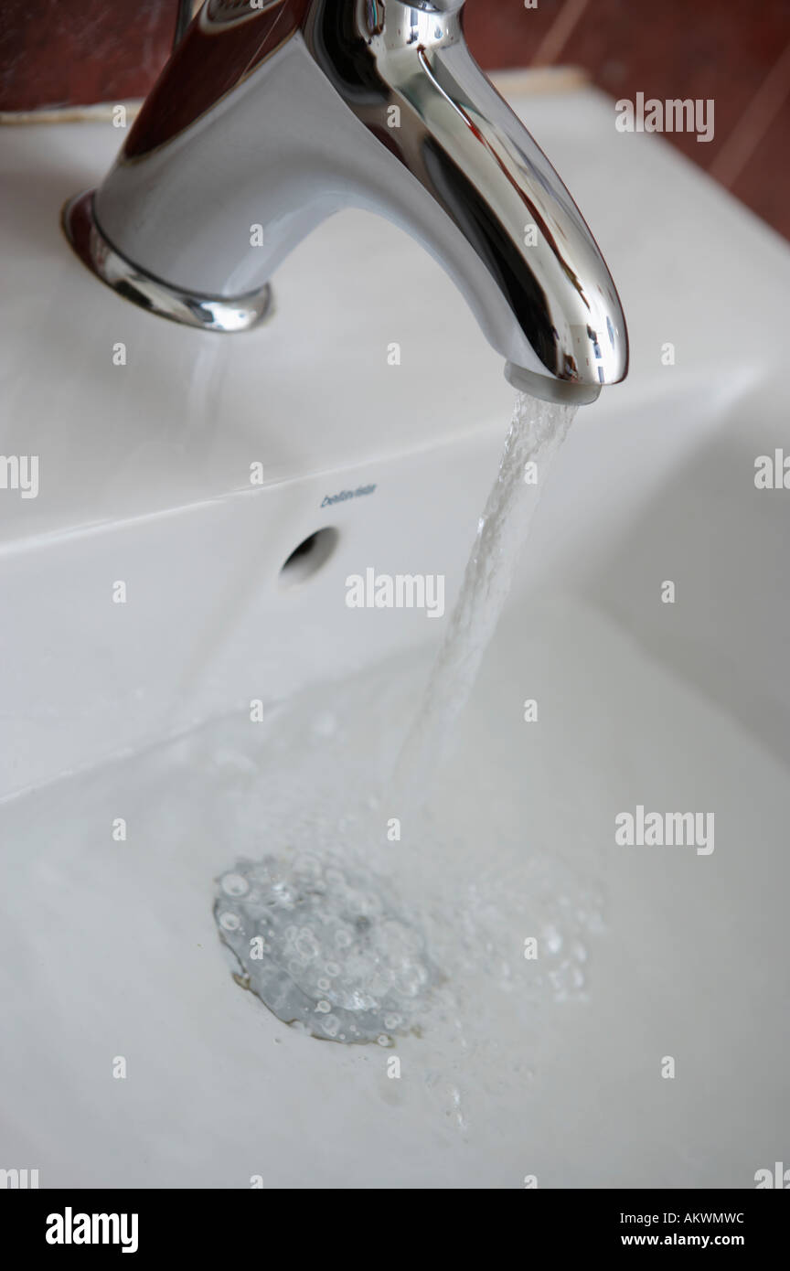 BATHROOM TAP POURING WATER INTO WASH BASIN Stock Photo - Alamy