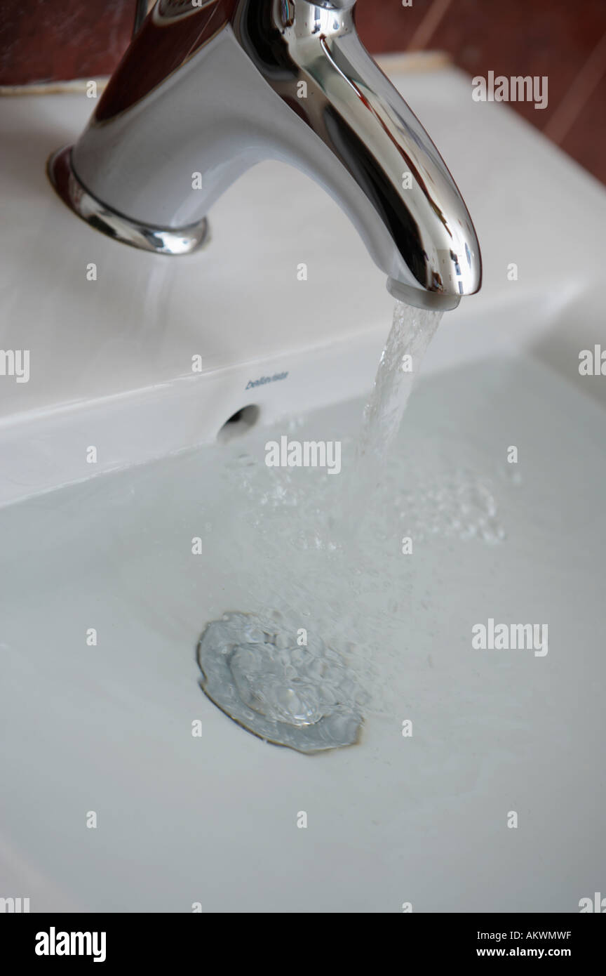 BATHROOM TAP POURING WATER INTO WASH BASIN Stock Photo - Alamy