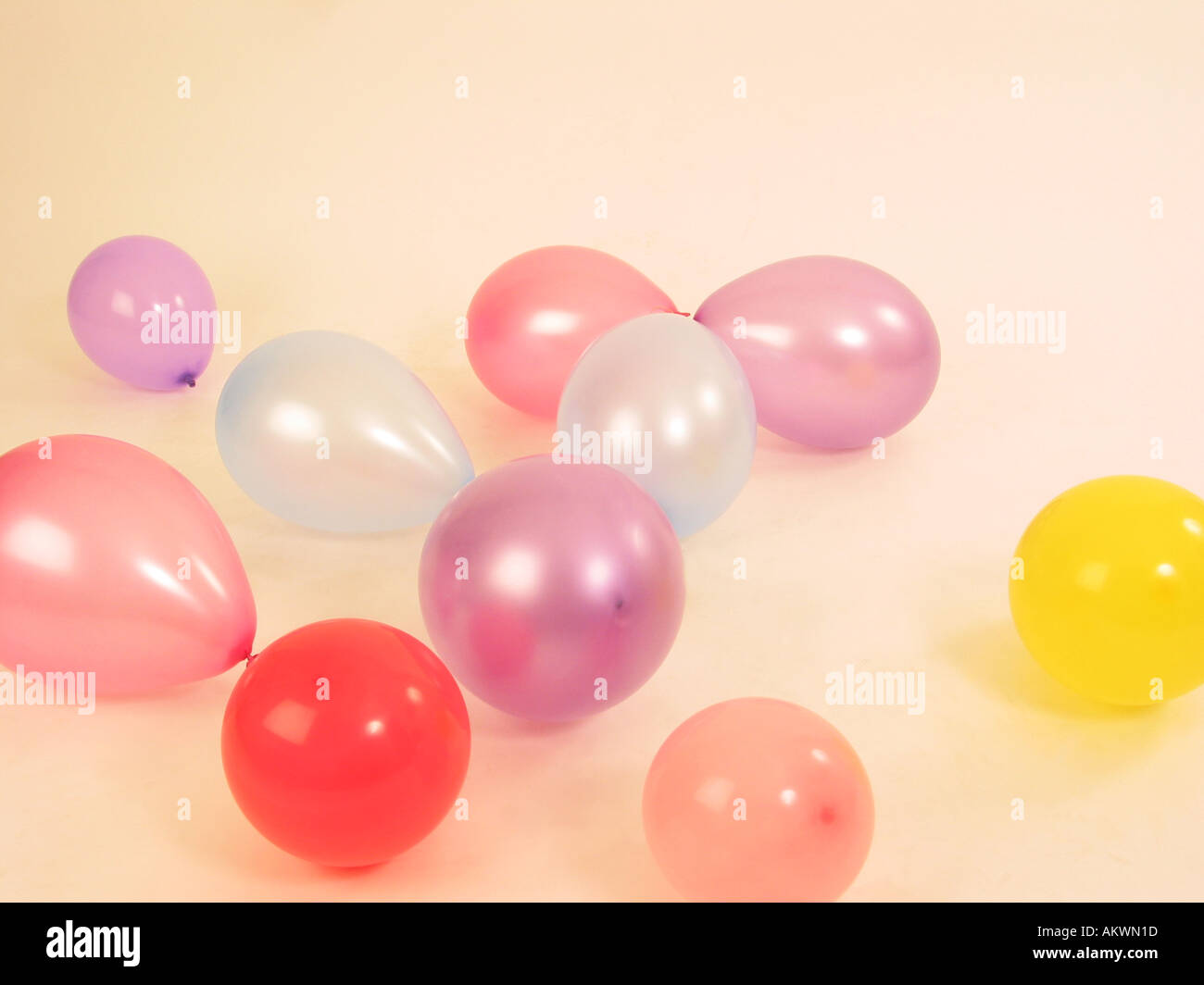 a number of scattered balloons on floor after party Stock Photo - Alamy
