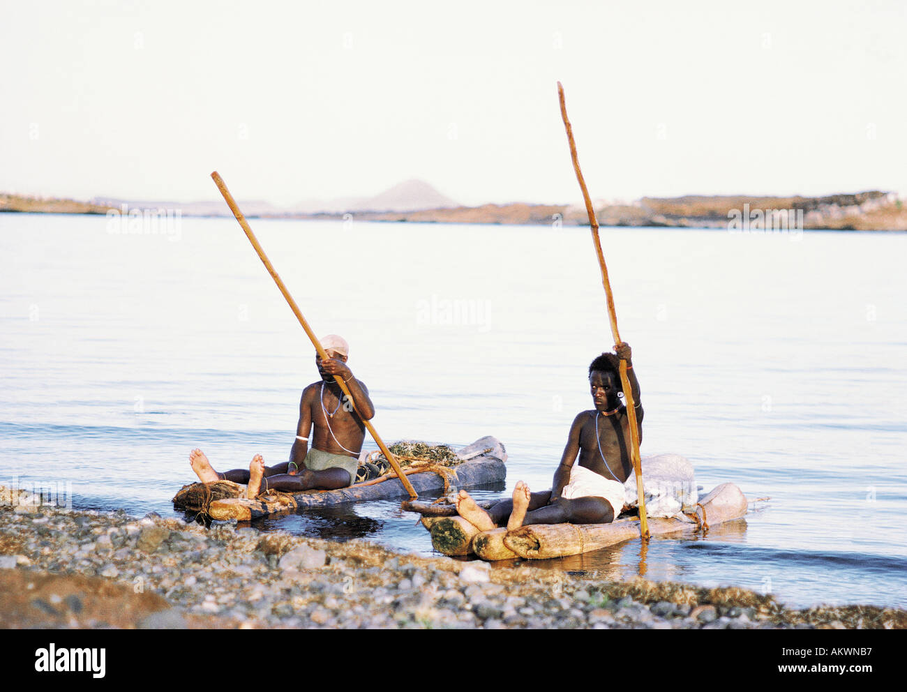 Two El Molo fishermen on rafts made of palm logs Lake Turkana northern ...