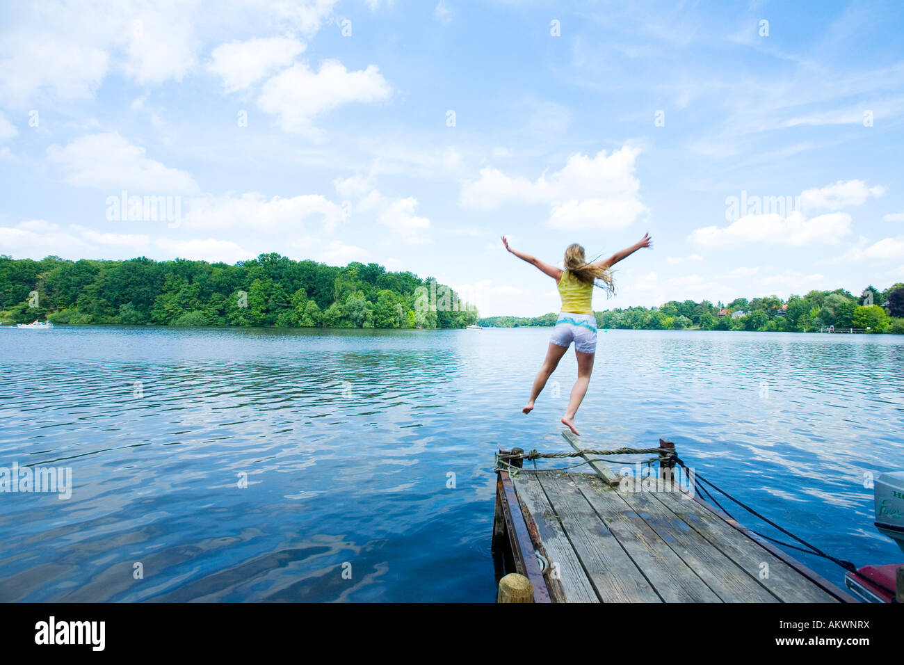 Woman Jumping into Lake, rear view Stock Photo - Alamy