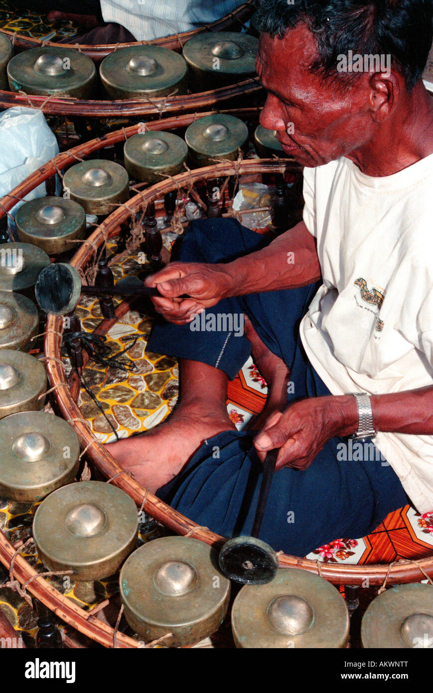 Cambodia, Phnom Penh, Cambodian man playing traditional musical ...